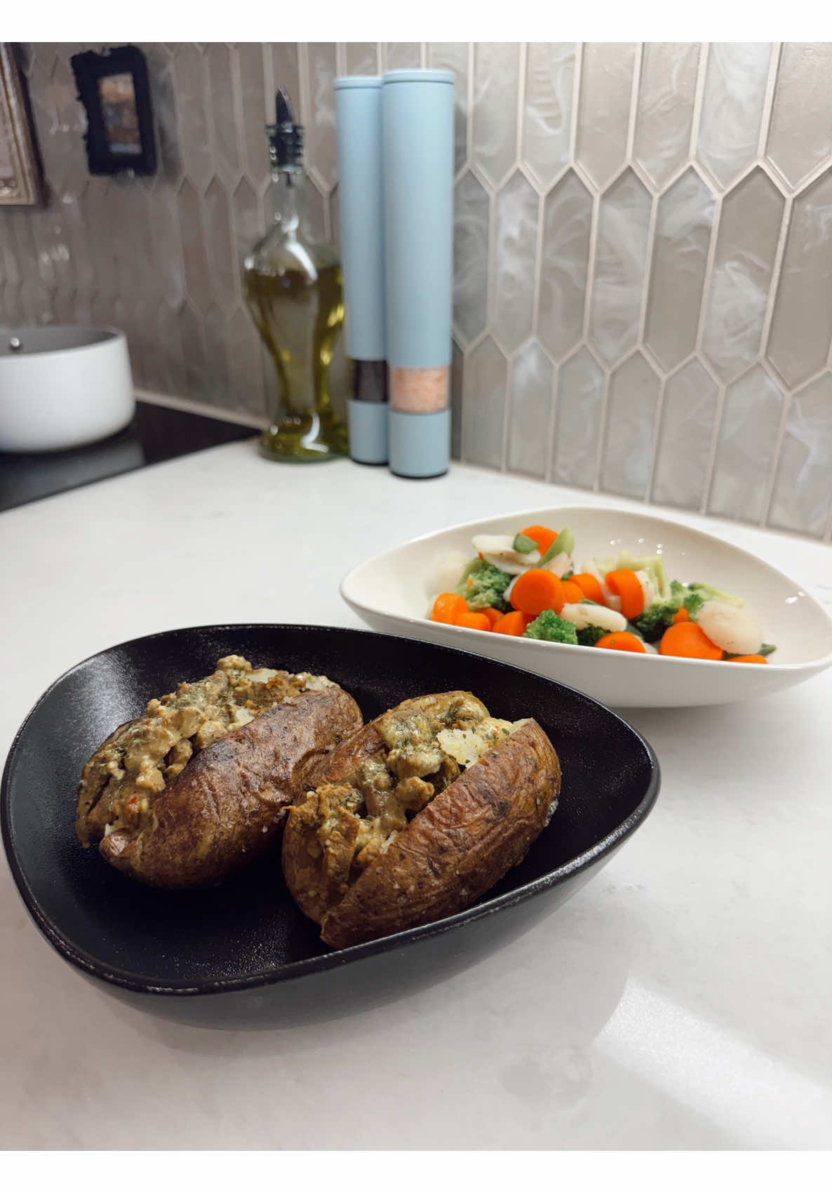 Making loaded stuffed baked potatoes alongside fresh healthy steamed ...